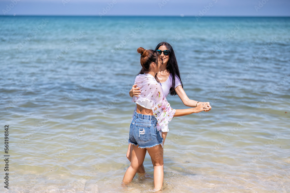 Couple LGBTQ girl on holiday happy running playing dancing along the ...
