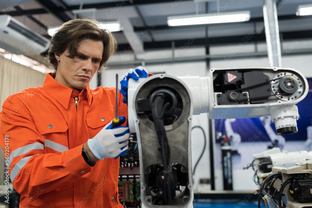 Male engineer worker using screwdriver maintenance automatic welding ...