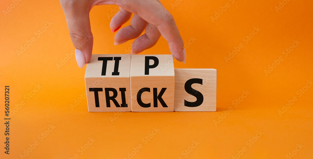 Tips and Tricks symbol. Businessman Hand turns cubes and changes word ... Tips and Tricks symbol. Businessman Hand turns cubes and changes word ...