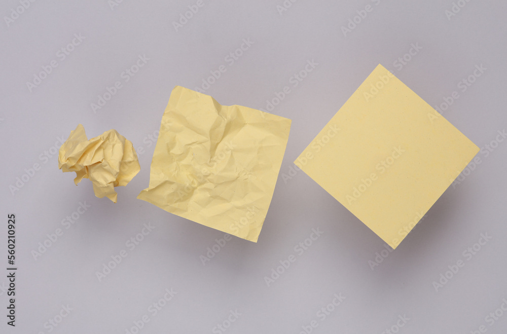 Step by step process of crumpling paper into a ball on gray background ...