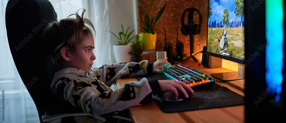 Image of immersed teenage gamer boy playing video games on computer in ...