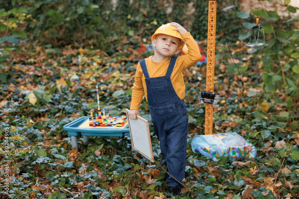 Little boy child future engineer builder architect with safety helmet ...