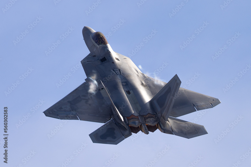 Very close top view of a F-22 Raptor in a high G maneuver, with ...