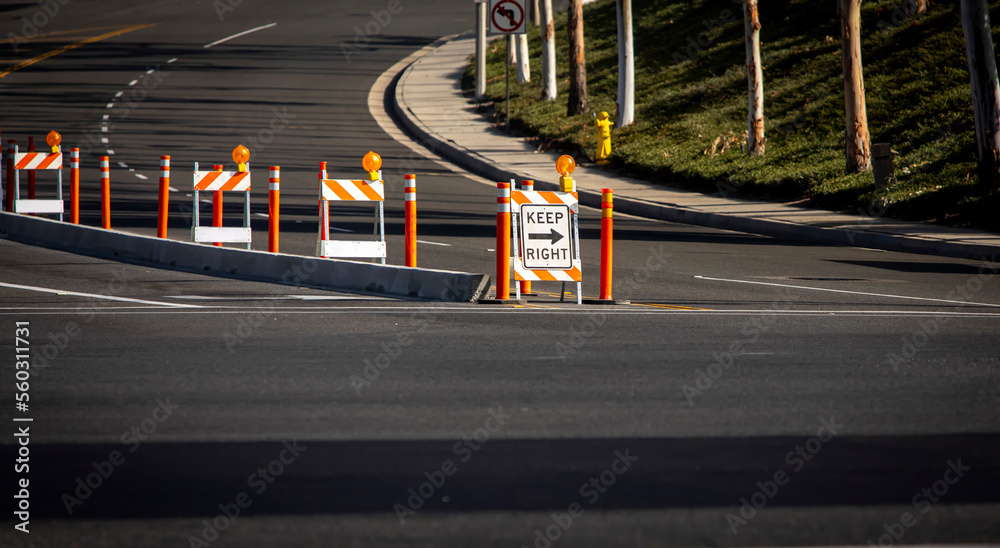 Traffic sign and cones around construction of a cement street island ...