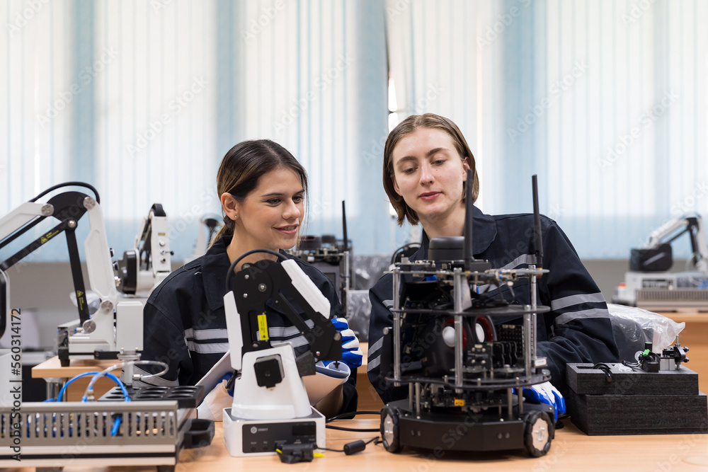Two female engineers worker discuss and training or maintenance AI ...