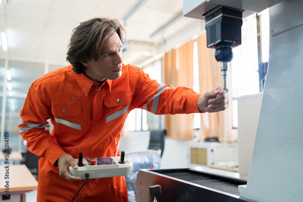 Male engineer worker working and maintenance CMM machine at production ...