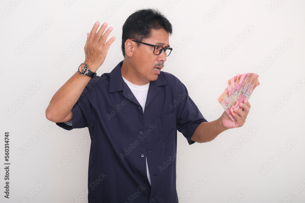 Man standing, looking unhappy and confused trying to safe his only left ...