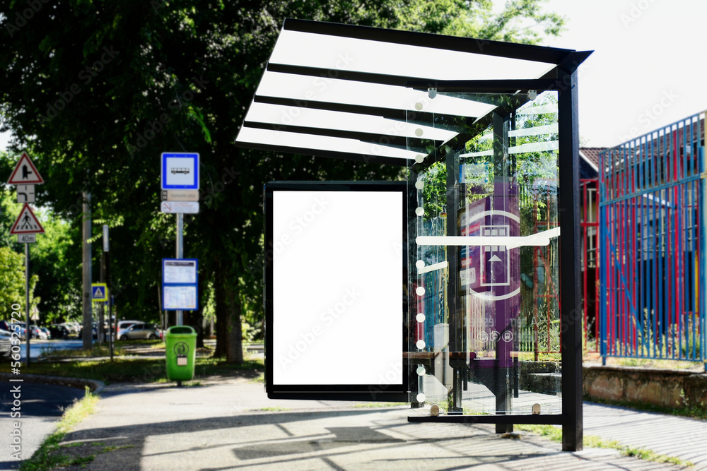 blank white lightbox and glass bus shelter at busstop. empty vertical ...