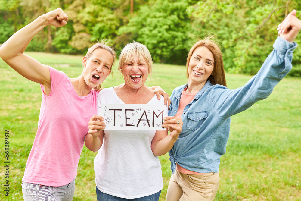 Three women cheering with team sign in hands Stock Photo | Adobe Stock