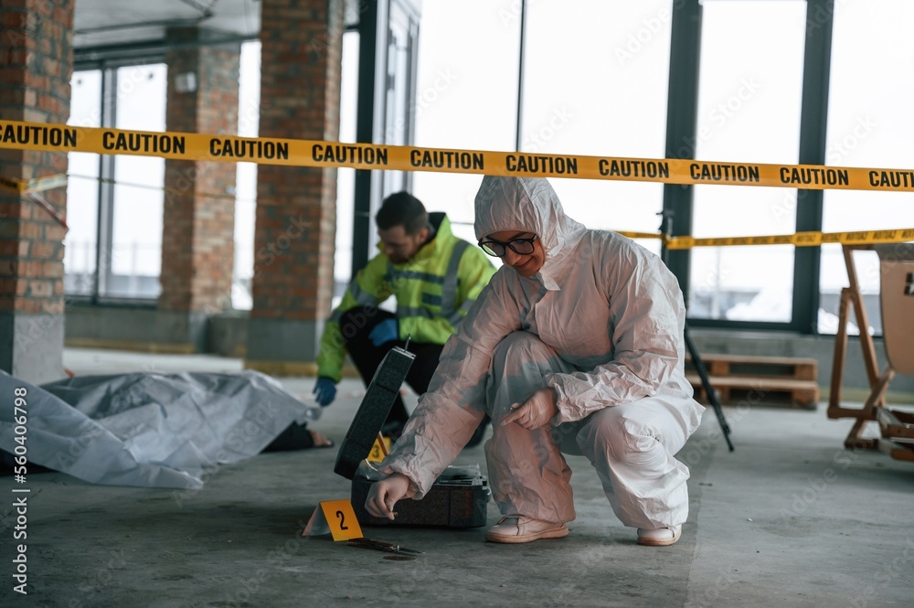 Knive and blood is on the ground. Detectives are collecting evidence in ...