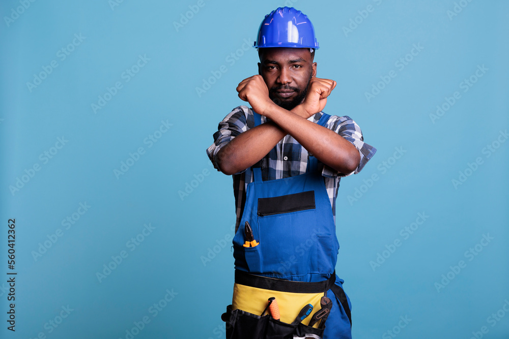 Disapproving african american builder making stop gesture with crossed ...