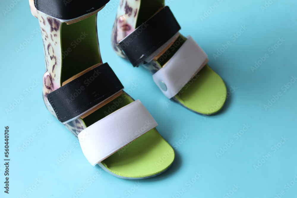 Child cerebral palsy disability, legs orthosis. Stock Photo | Adobe Stock