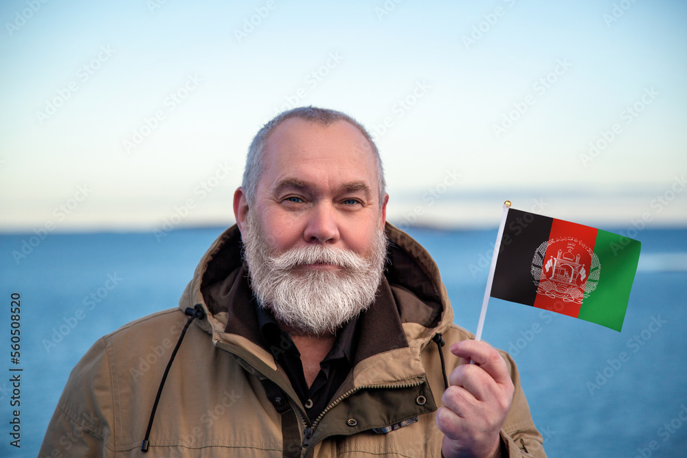 Man holding Afghanistan flag. Portrait of older man with a national ...