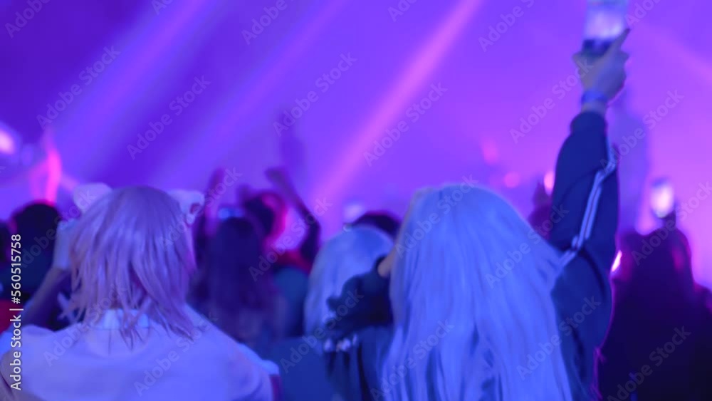 Slow motion: teenage girl partying, cheering, raising hands up and ...