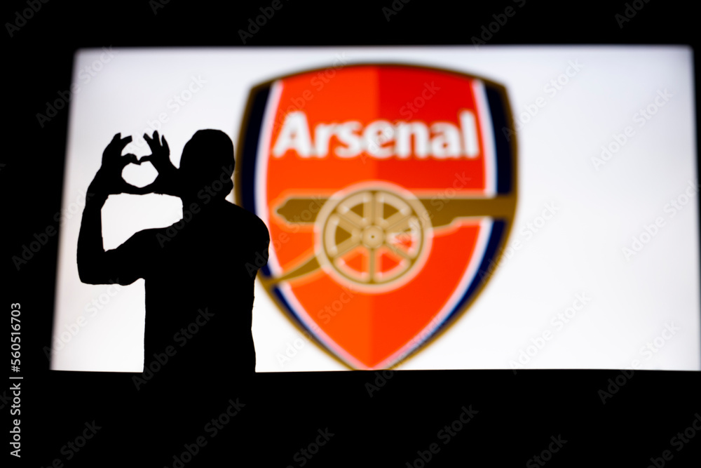 Young man making heart shape with his hands front of Arsenal logo, love ...