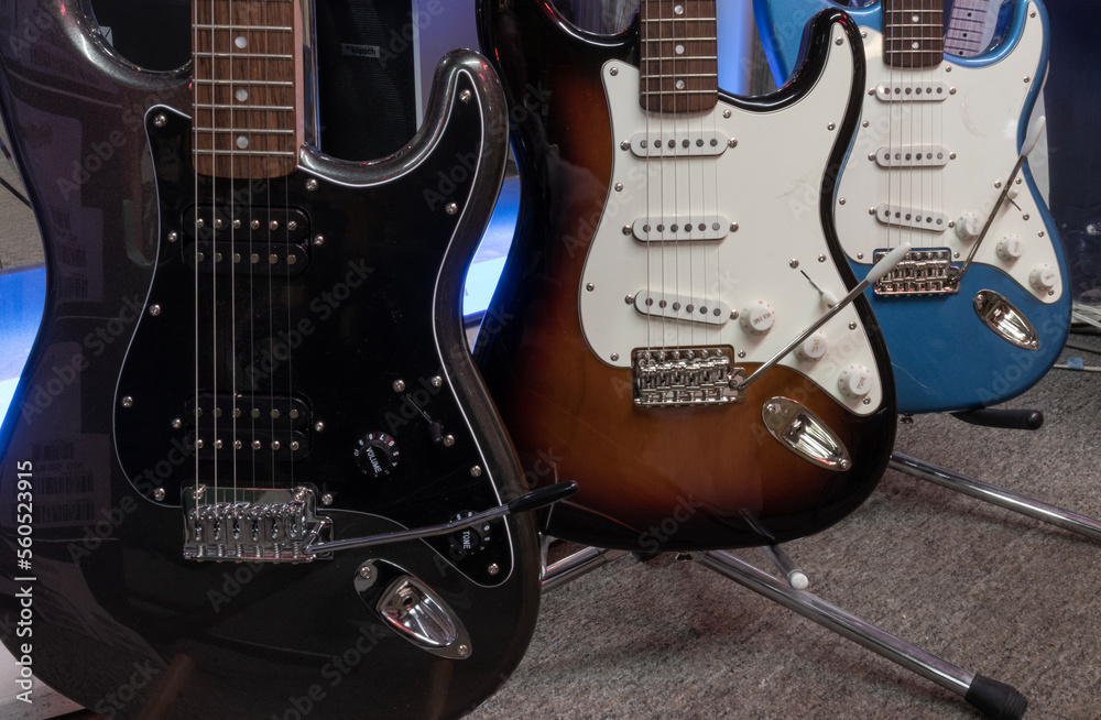 Fender Stratocaster guitar display at a music store. Strats are world ...