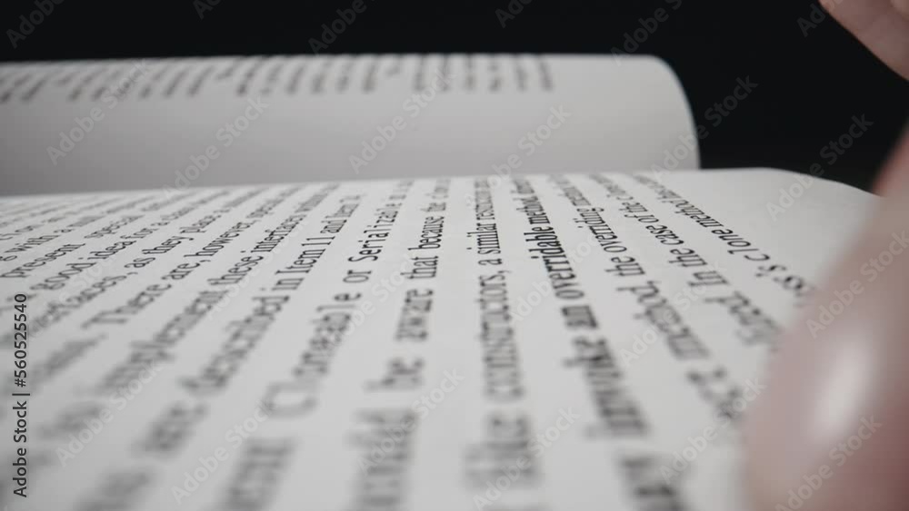 Cropped view of a man underlining text with his forefinger while ...
