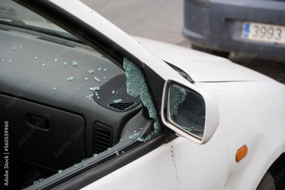 Broken co-pilot window. Broken window of an old car. Vandalism of a car ...