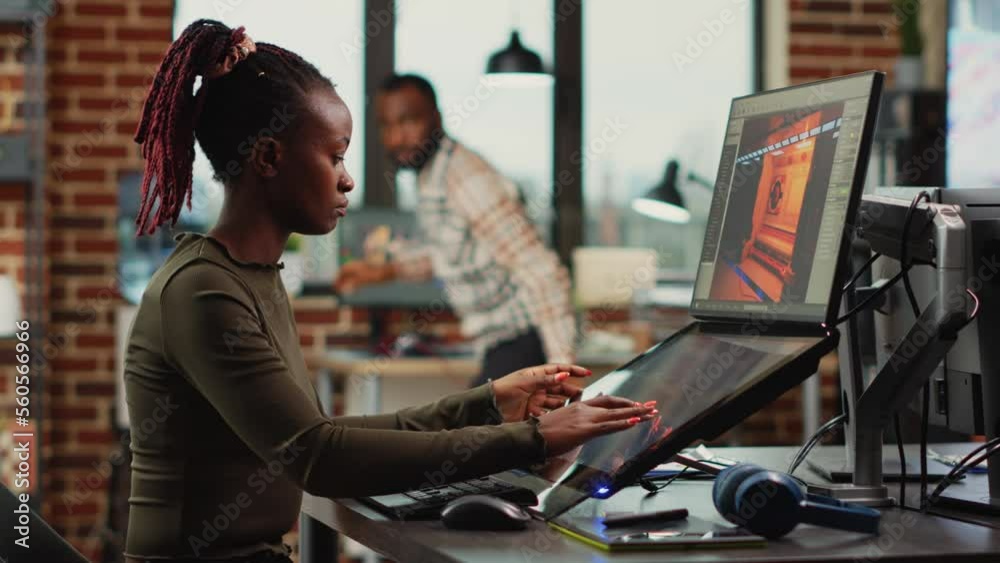 African american woman designing game interface on computer with ...