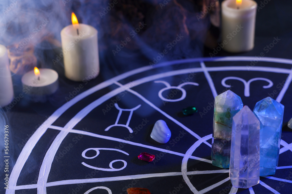 Natural stones for zodiac signs, drawn astrology chart and burning ...