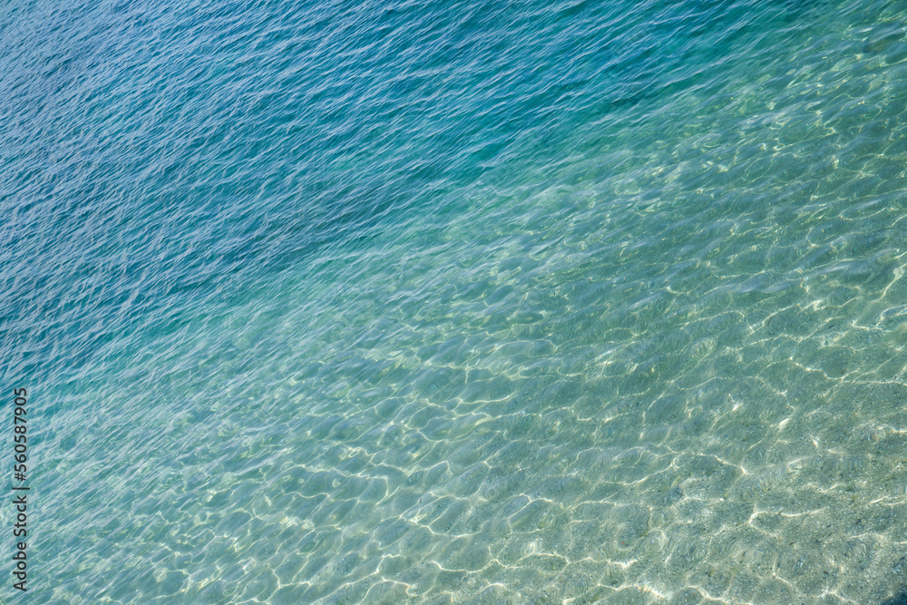 Marine water surface, sun's rays shimmer on water surface, diagonal ...