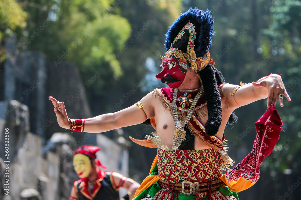 Traditional Javanese dancer practicing a mask dance with complete ...