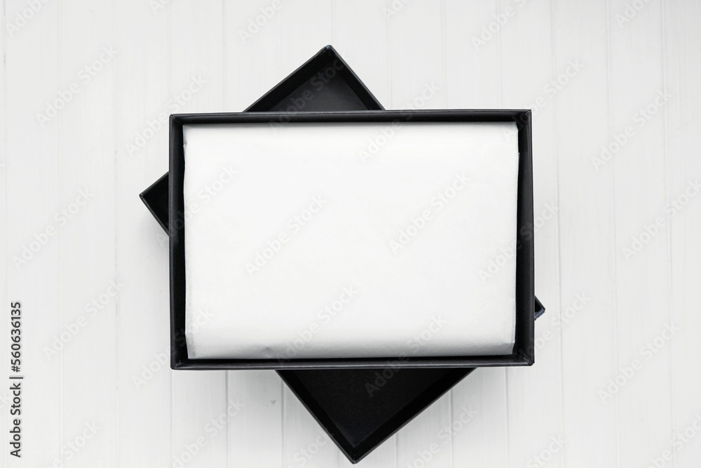 Small black box with wrapping paper, open gift box, package, parcel ...