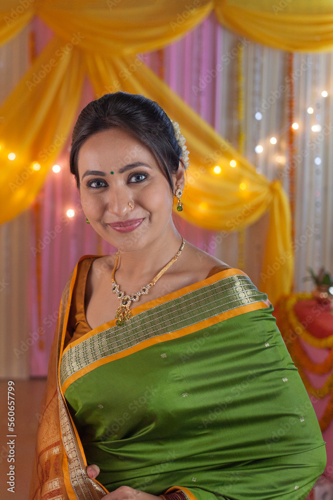 Beautiful Indian lady draped in traditional saree with festive ...