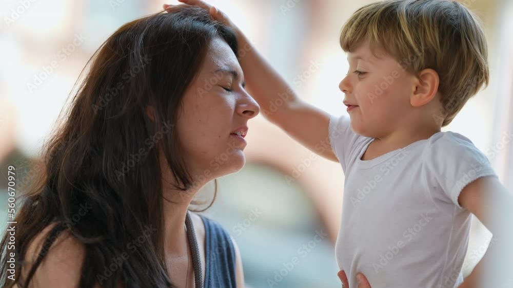 Parenting stress. Patient mother. Little boy hitting parent in the head ...