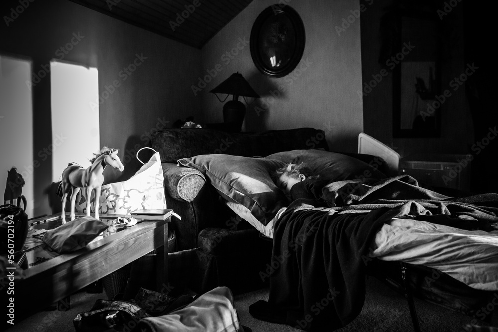 Boy sleeping in dark room with window light Stock Photo | Adobe Stock