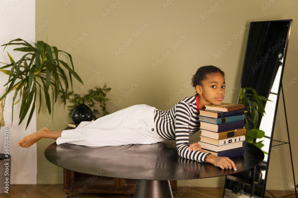Teen girl lying on a table in studio Stock Photo | Adobe Stock
