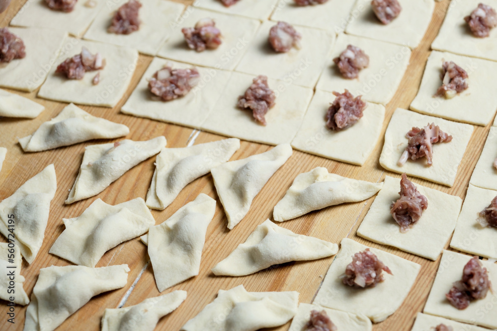 Turkish Ravioli on a wooden table. The Turkish local name is "mantı ...