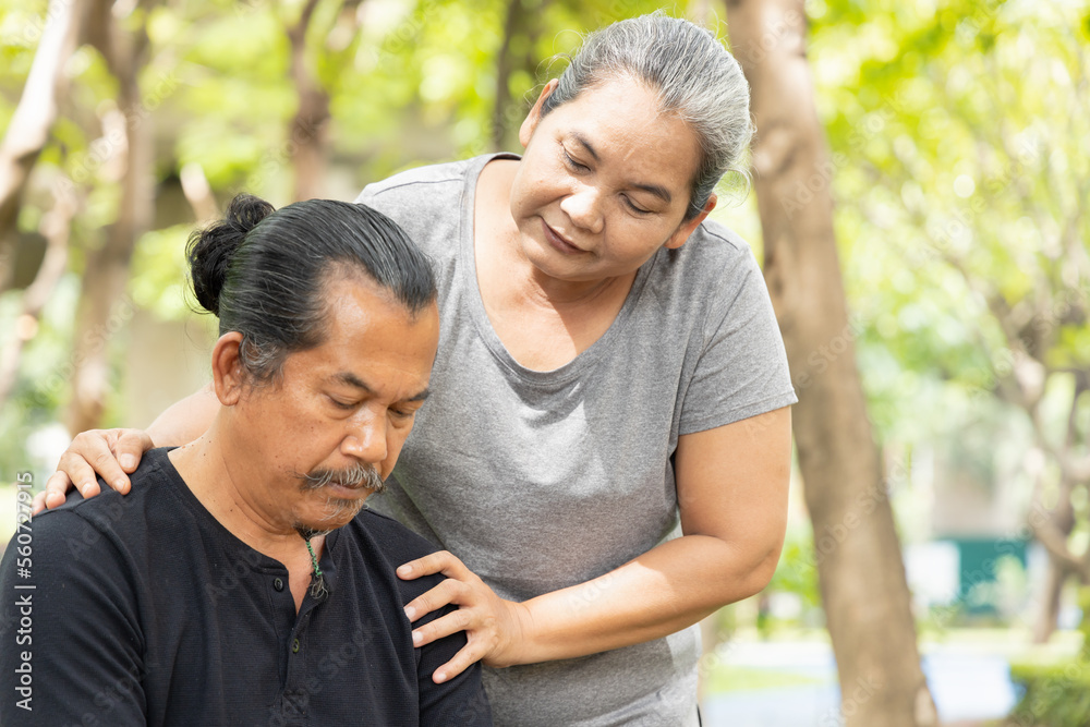 Old senior woman hugging, taking care of her husband suffering from ...