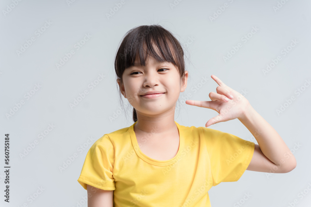An adorable little asian girl show her hand, the sign hand language "I ...