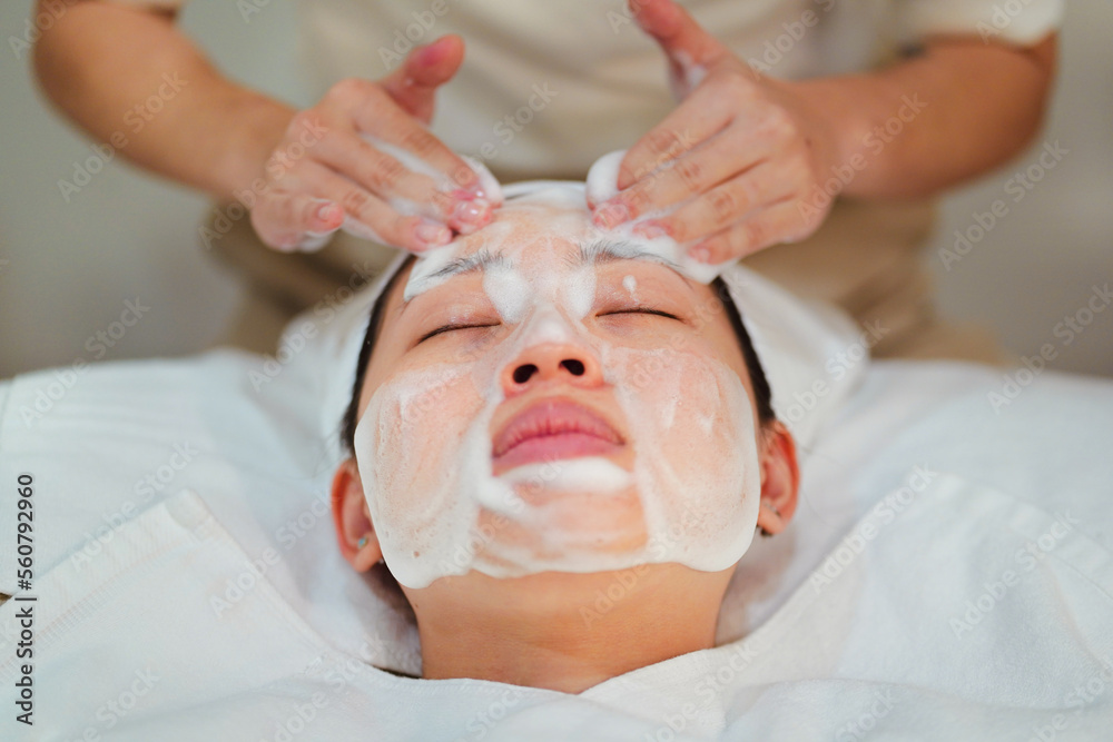 Crop beautician doing facial cleansing procedure Stock Photo | Adobe Stock