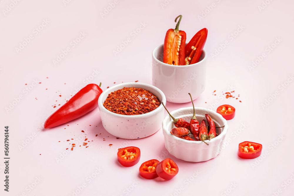 Bowls of chipotle chili flakes, fresh and dried jalapeno peppers on ...