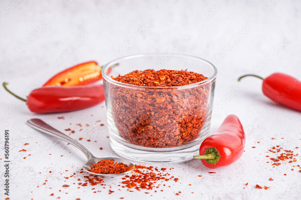 Bowl of chipotle chili flakes on light background Stock Photo | Adobe Stock