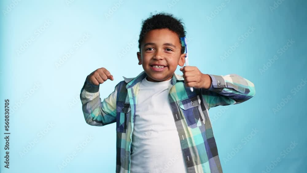 Cute little african american boy with teeth brush in his hand showing ...
