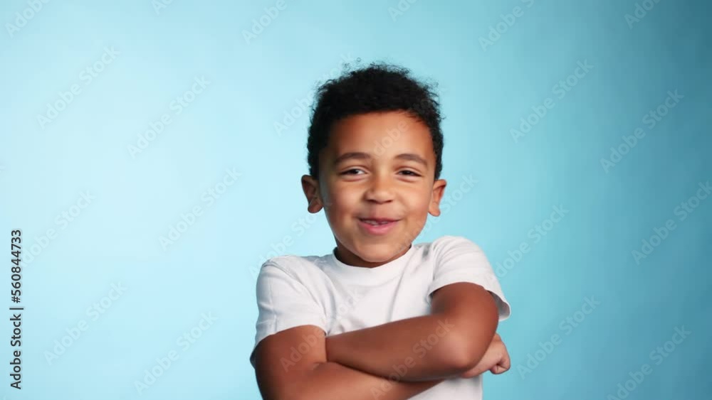 Portrait of little african american boy with crossed arms shows ...