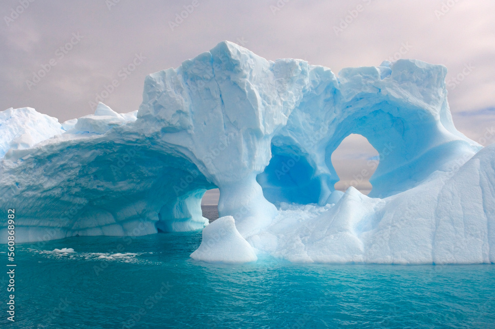 arched iceberg floating off the western Antarctic peninsula, Antarctica ...