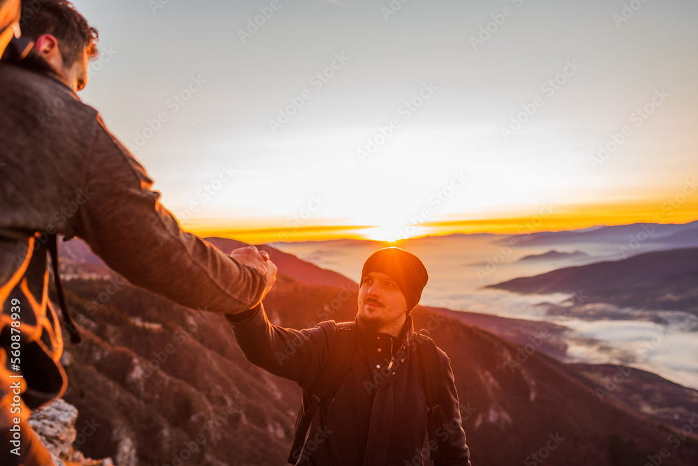 Hiking team people helping each other friend giving a helping hand ...
