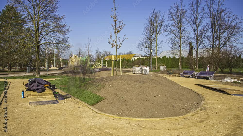 Gardeners Installing grass by unrolling sod rows in a residential ...