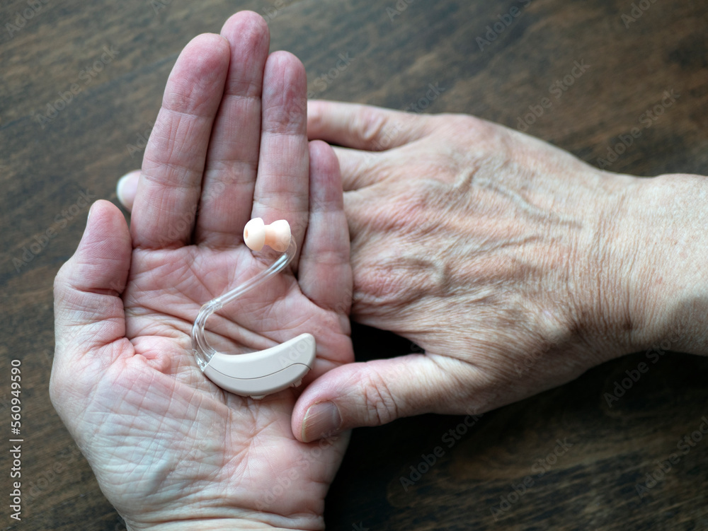 Hearing aid in human hands. Electronic medical device that is wore ...