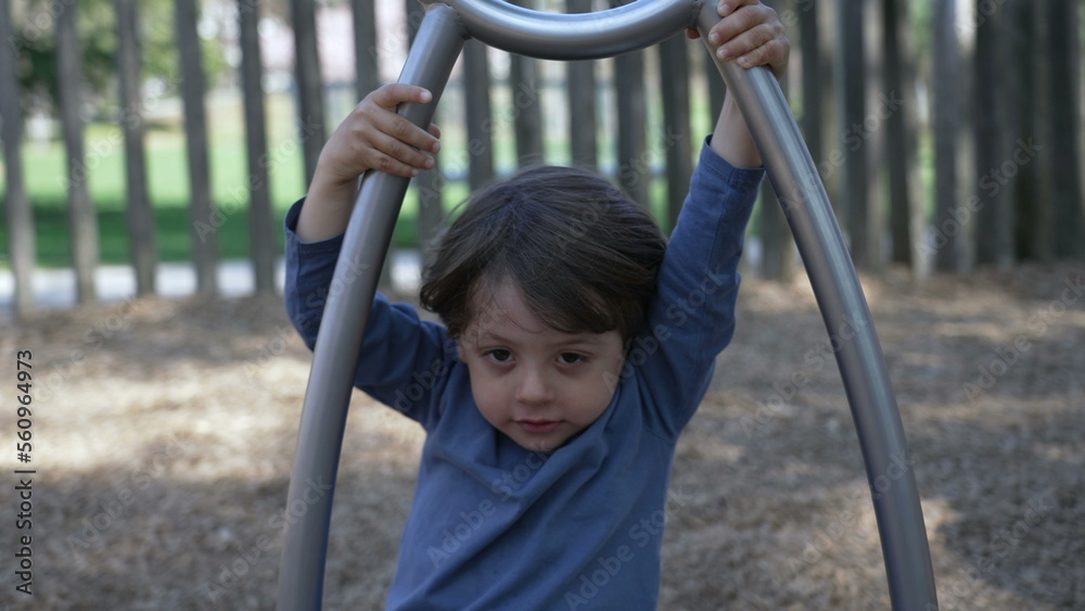 Child spinning at playground spinner structure. One little boy having ...