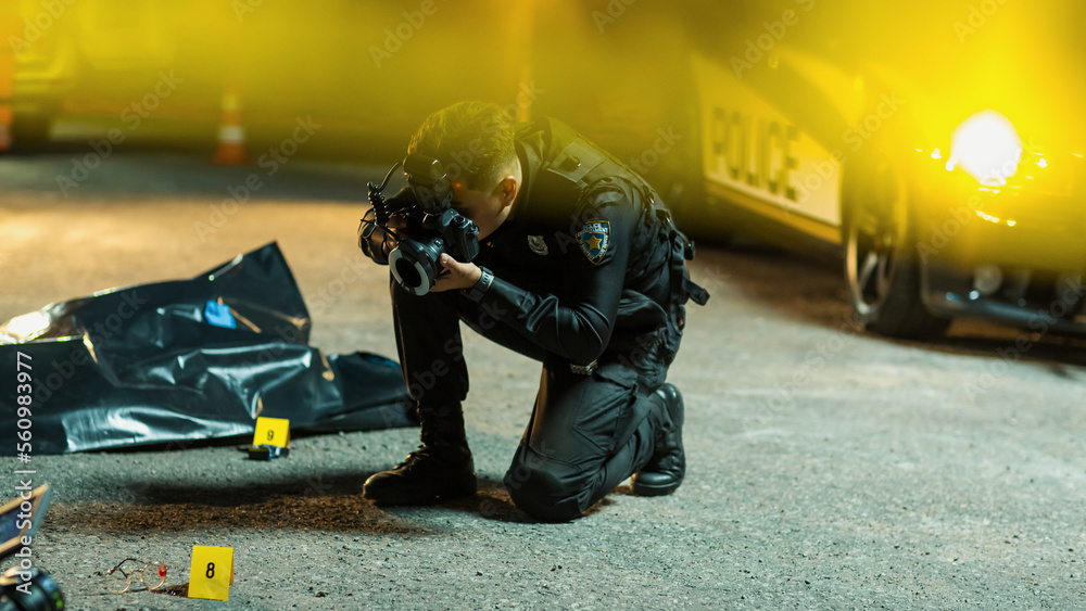 Young Police Officer Taking Forensic Photos of Evidence on a Crime ...