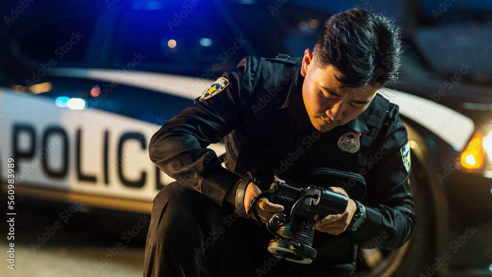 Policeman Checking Camera after Taking Forensic Photos of Evidence ...