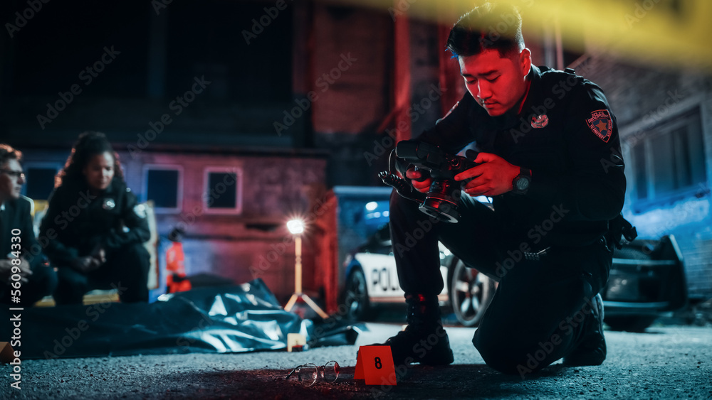 Policeman Taking Photos of Marked Evidence on a Crime Scene at Night ...