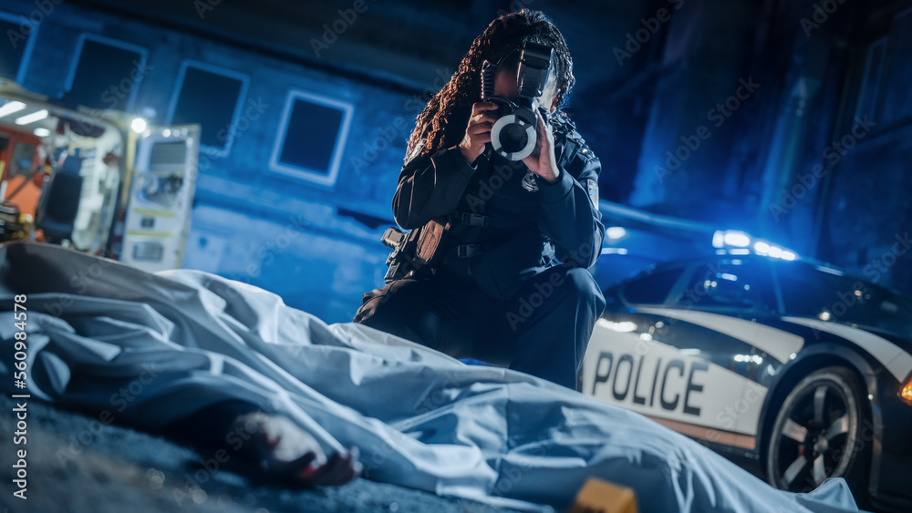 Black Female Police Officer Using Camera With Flash To Take Photos Of A