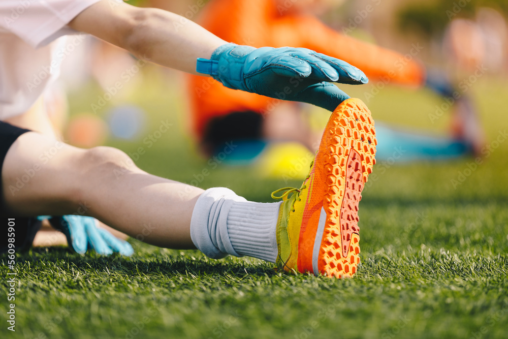 Stretches for young soccer goalies. Schoolboy at training session ...