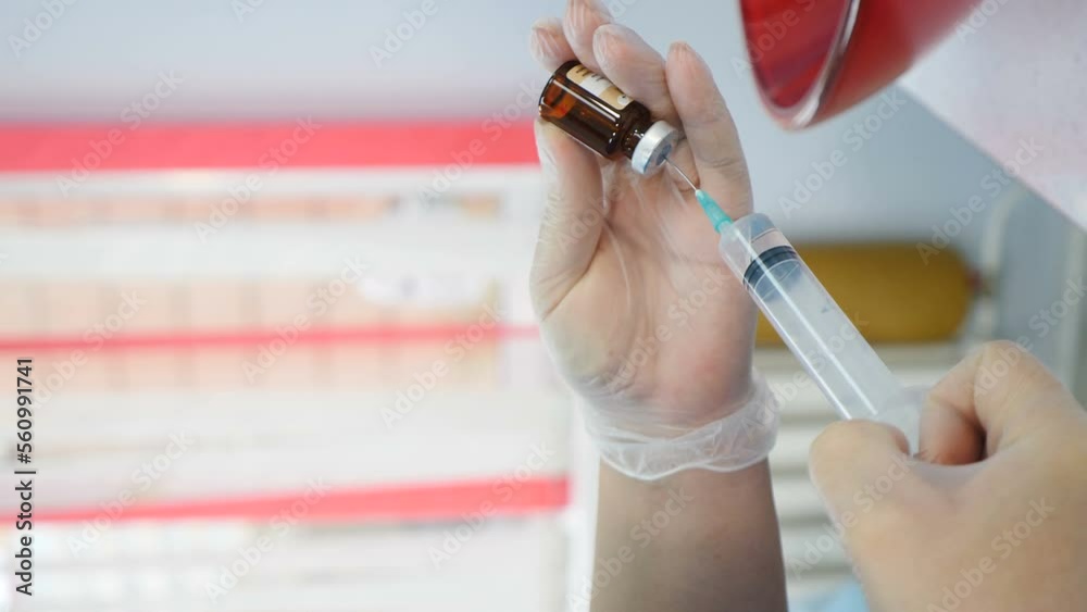 Beautician getting ready for invasive procedure filling syringe with ...